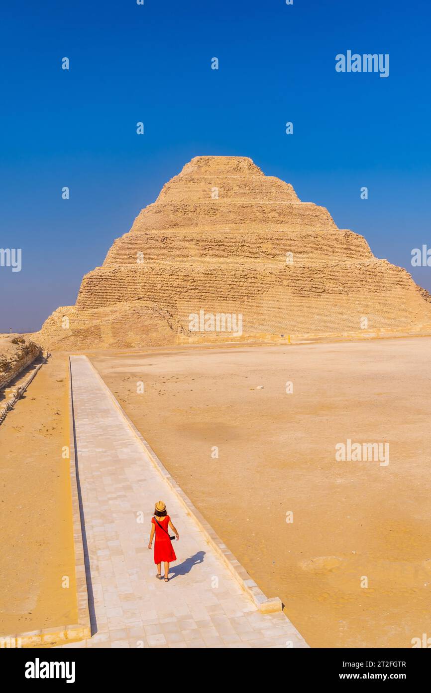 A young woman visiting the Stepped Pyramid of Djoser, Saqqara. Egypt ...