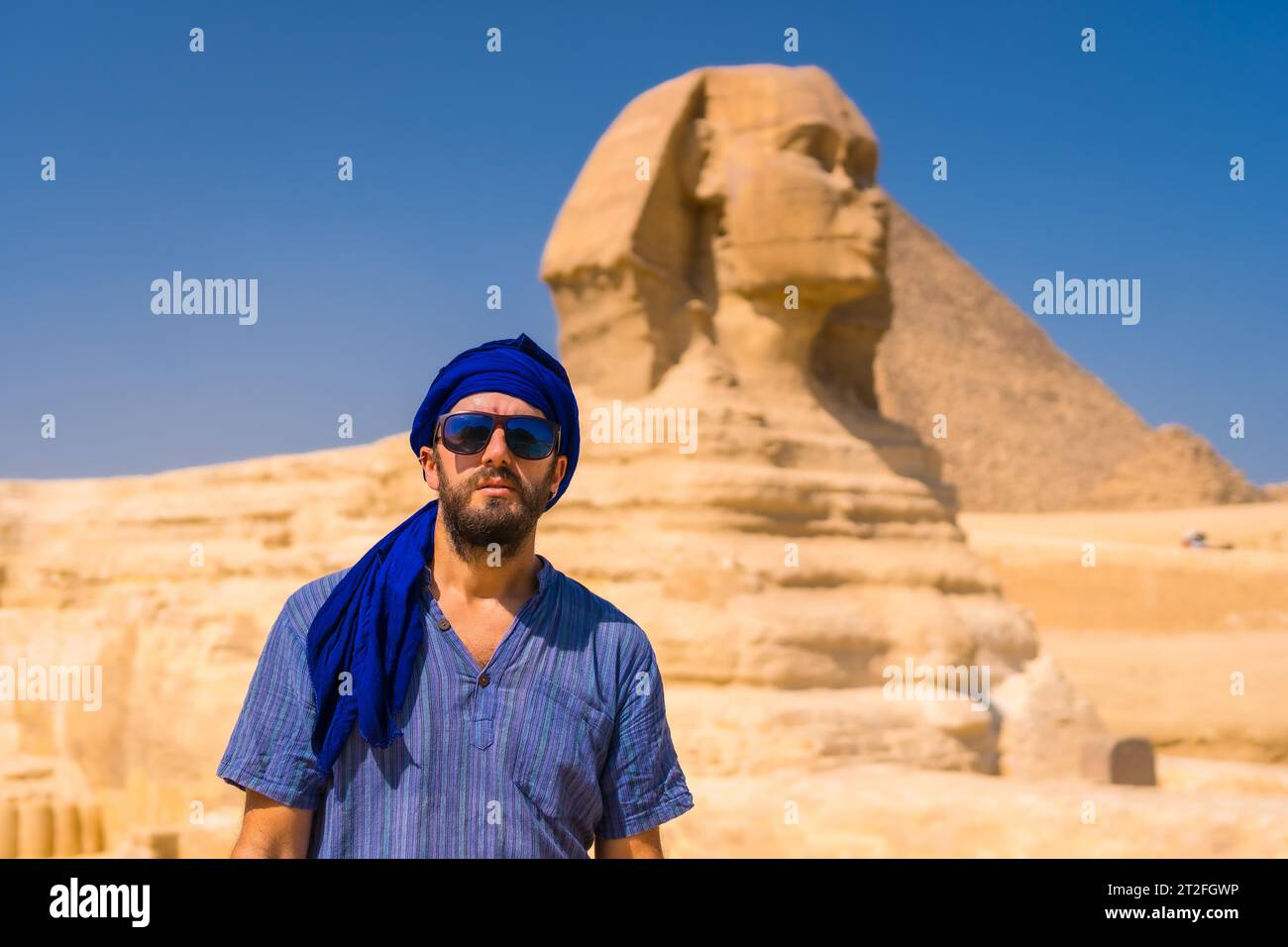 Portrait of a young tourist dressed in blue and a blue turban at the ...