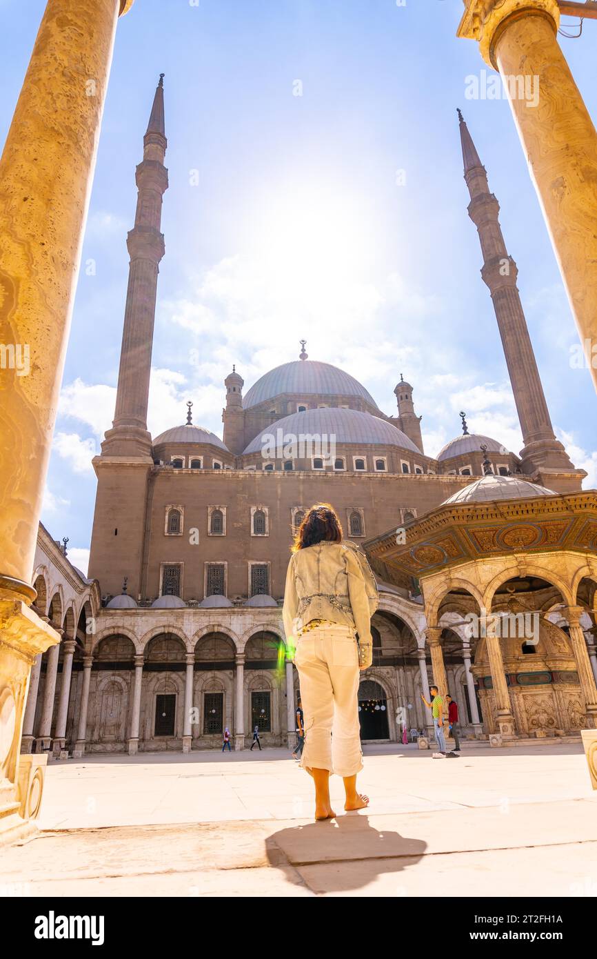 A young tourist walking in the inner courtyard of the Alabaster Mosque ...
