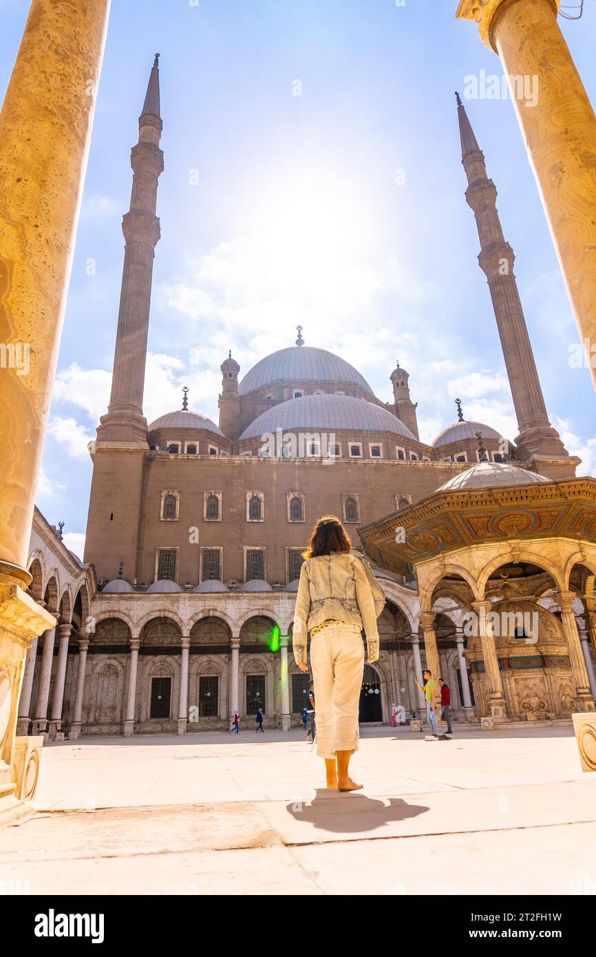 A young tourist walking in the inner courtyard of the Alabaster Mosque ...