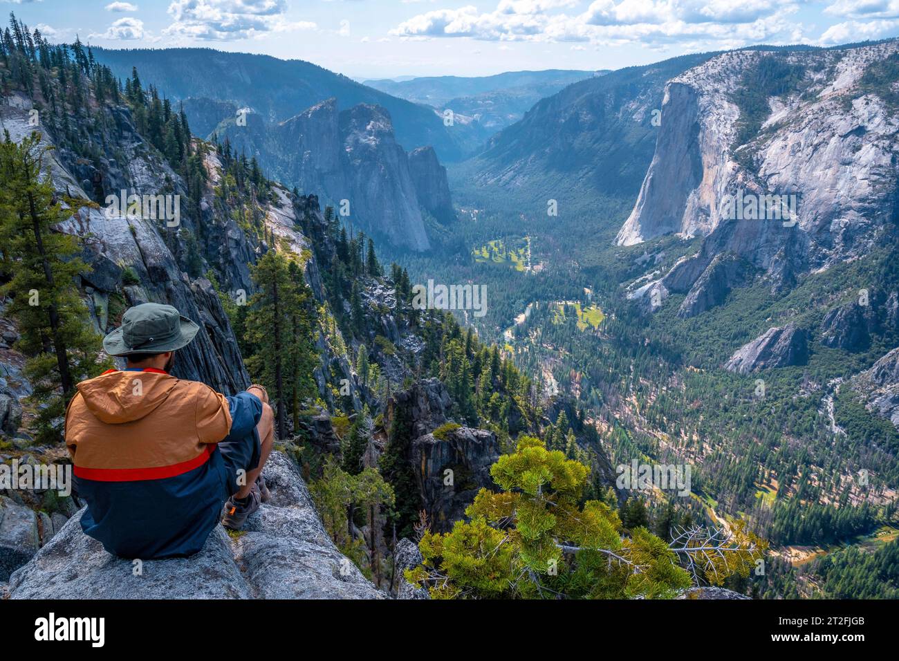 A young winged seated Taft point looking at Yosemite National Park and ...