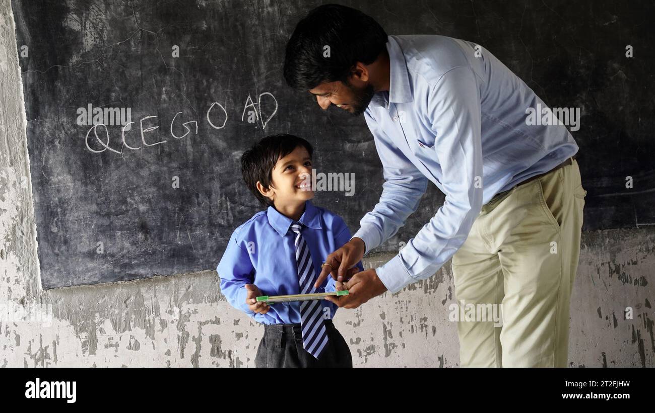 Indian teacher teaching to rural school student in classroom, Typical ...