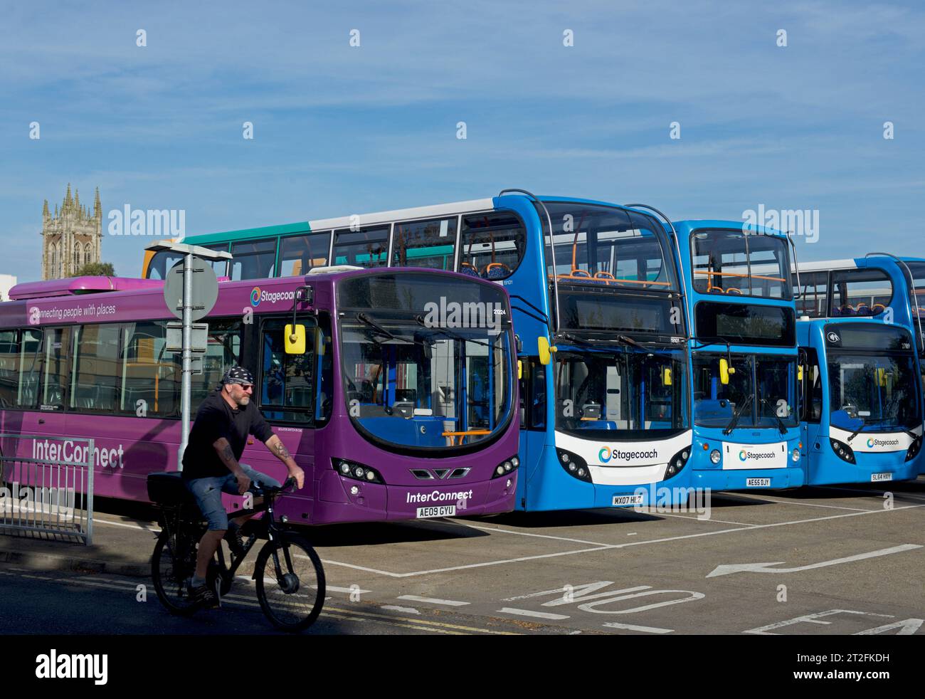 Man cycling past the bus station, Scunthorpe, Lincolnshire, England UK ...