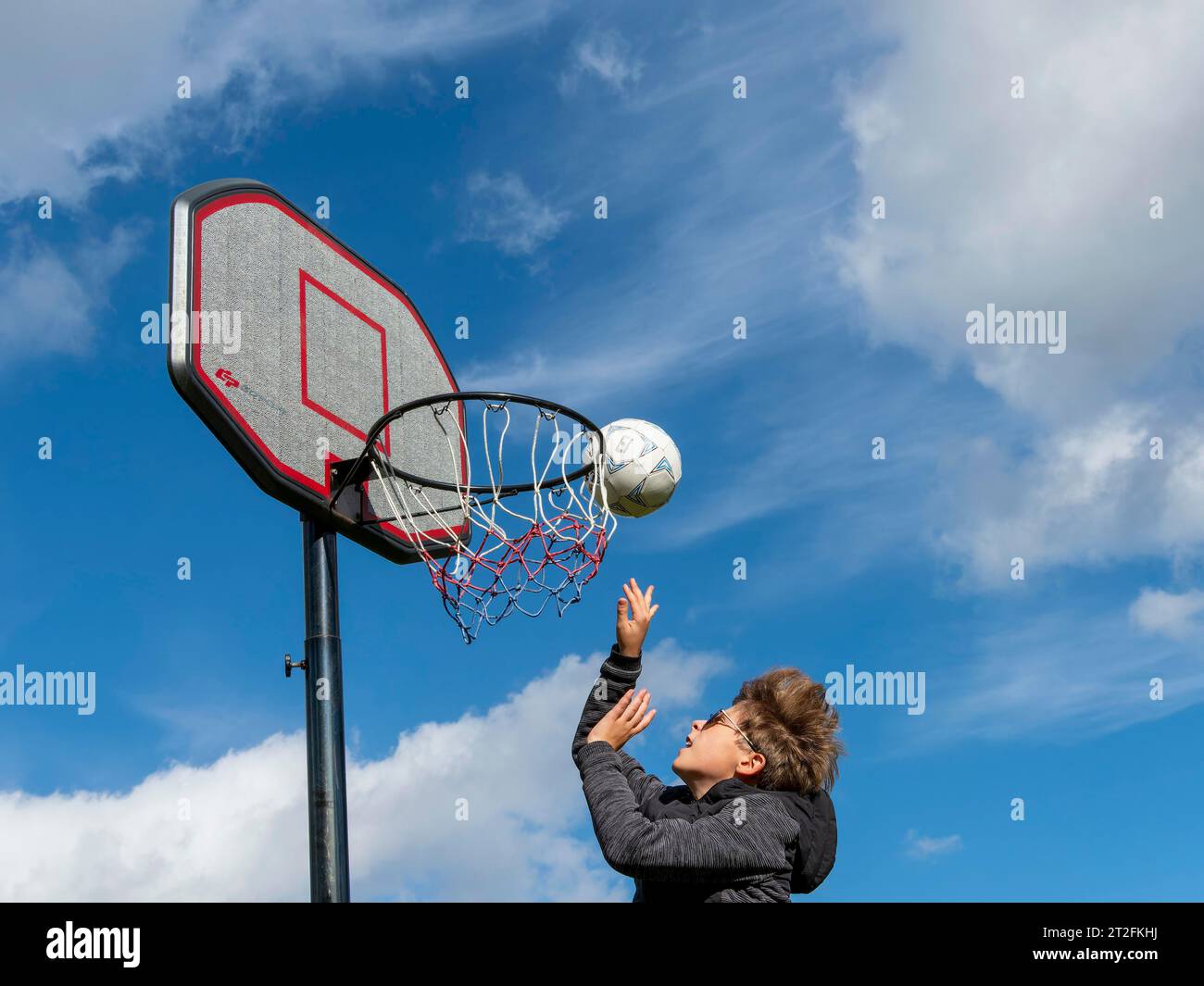 Basketball jumping with the ball to the basket and net, boy 10 years ...