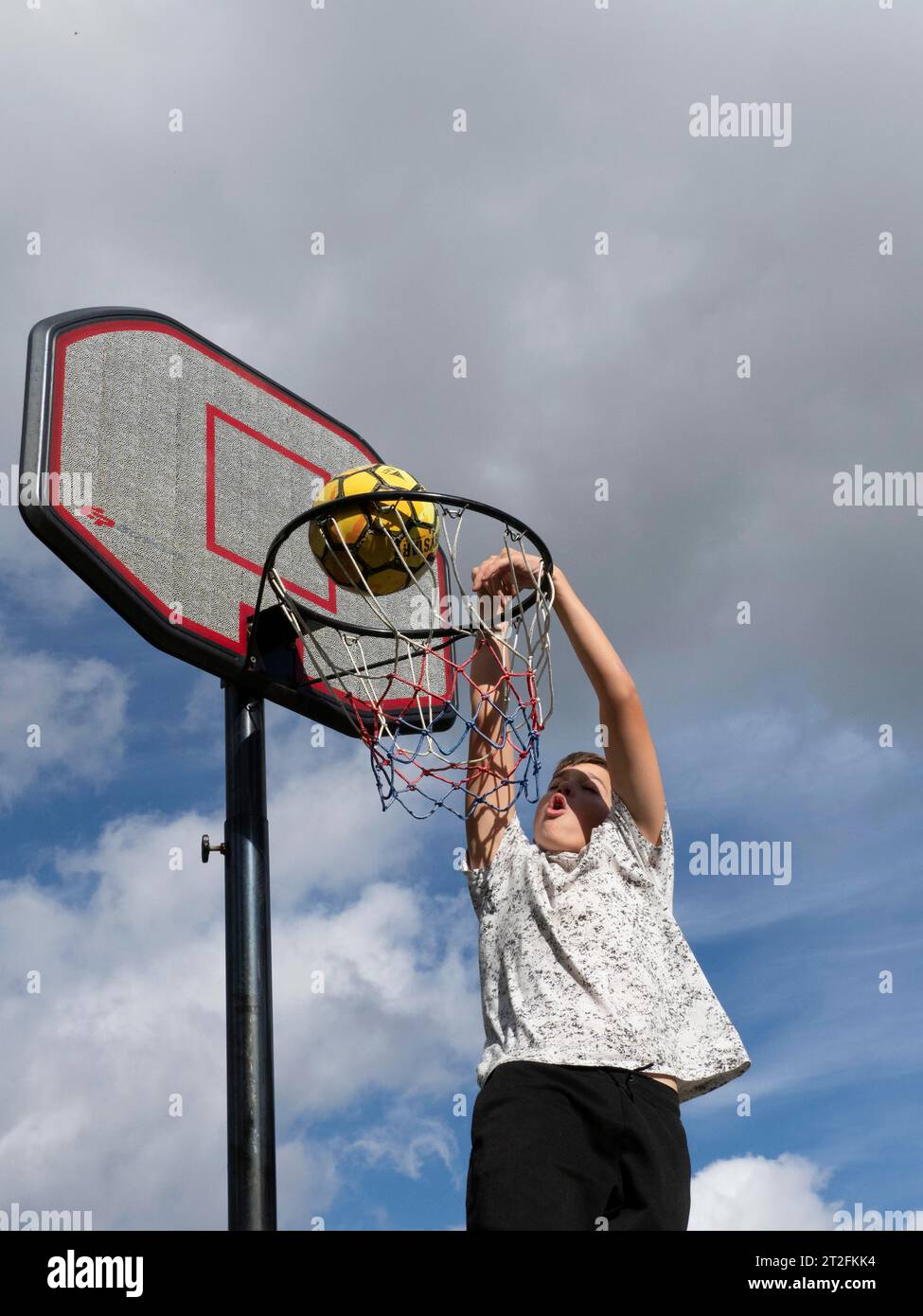 Basketball Jump with the ball to the basket and net, boy 13 years ...