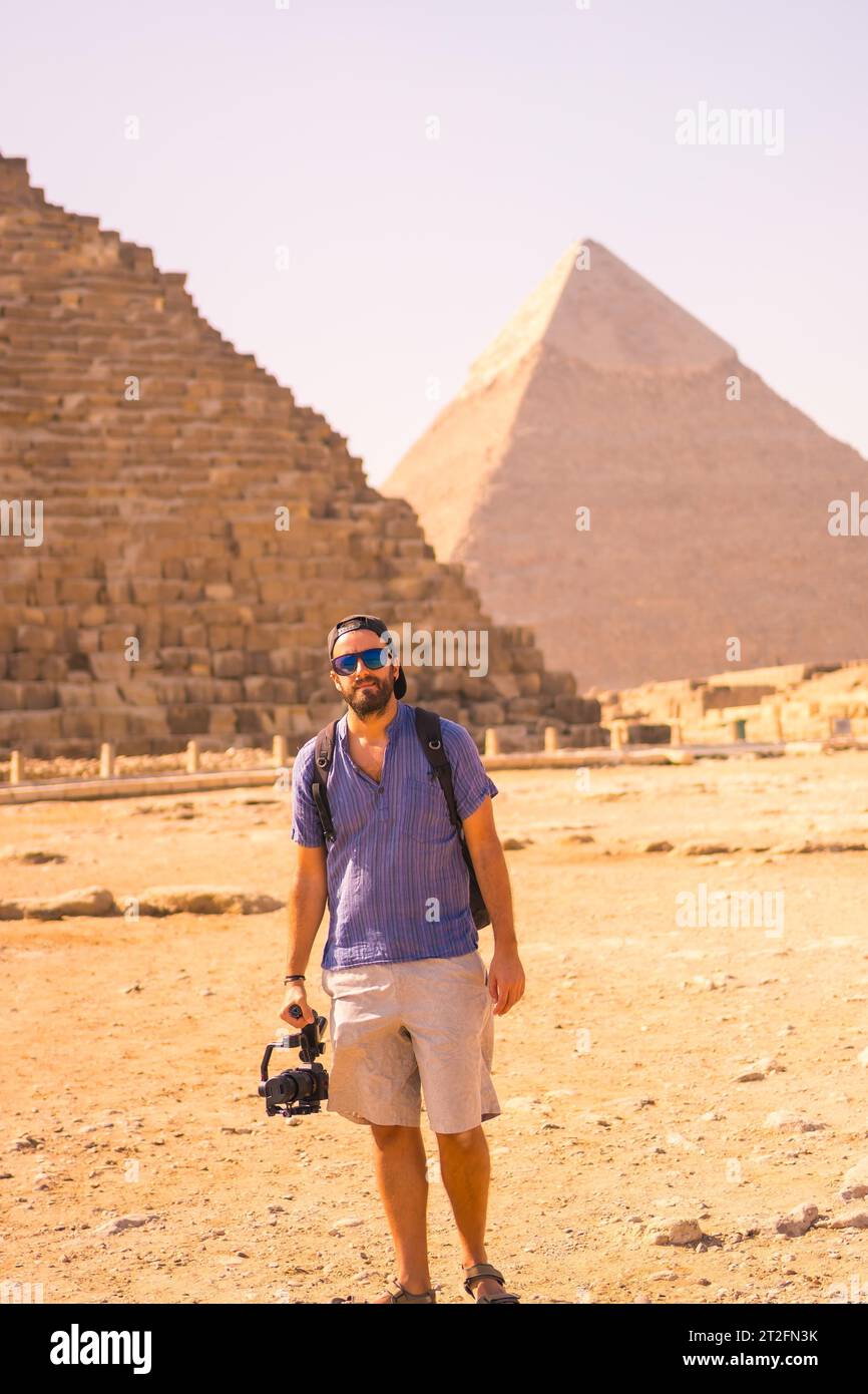 A young photographer at the pyramid of Cheops the largest pyramid. The ...