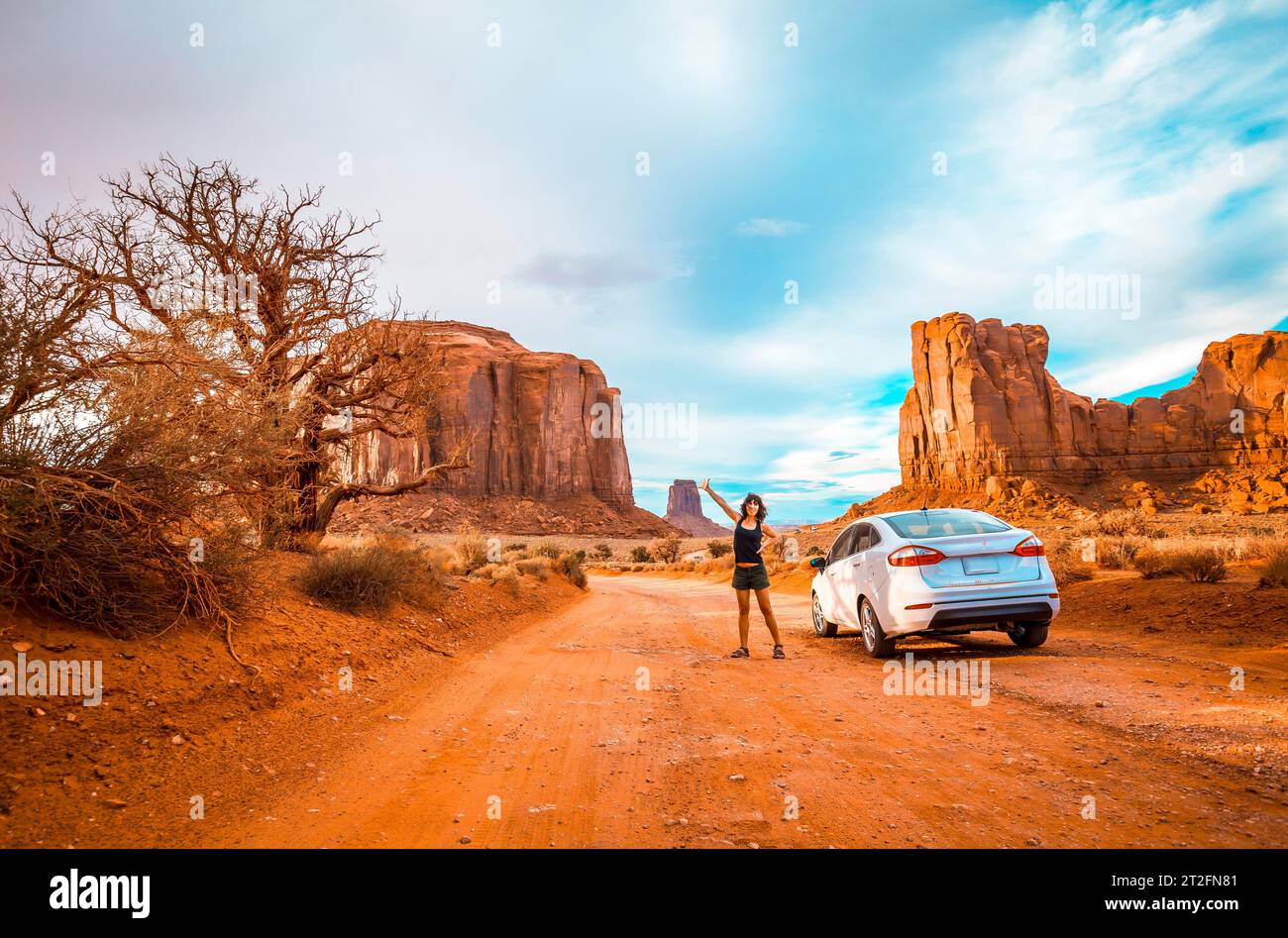A female tourist driving through the interior of Monument Valley, Utah ...