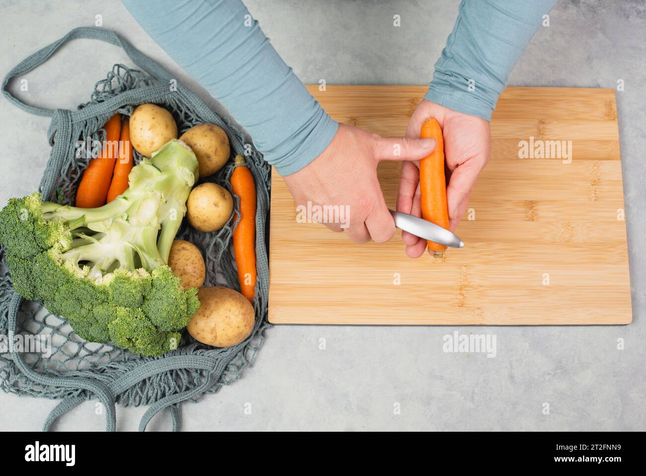 Peel carrot with scraper sharpener, prepare healthy food with ...