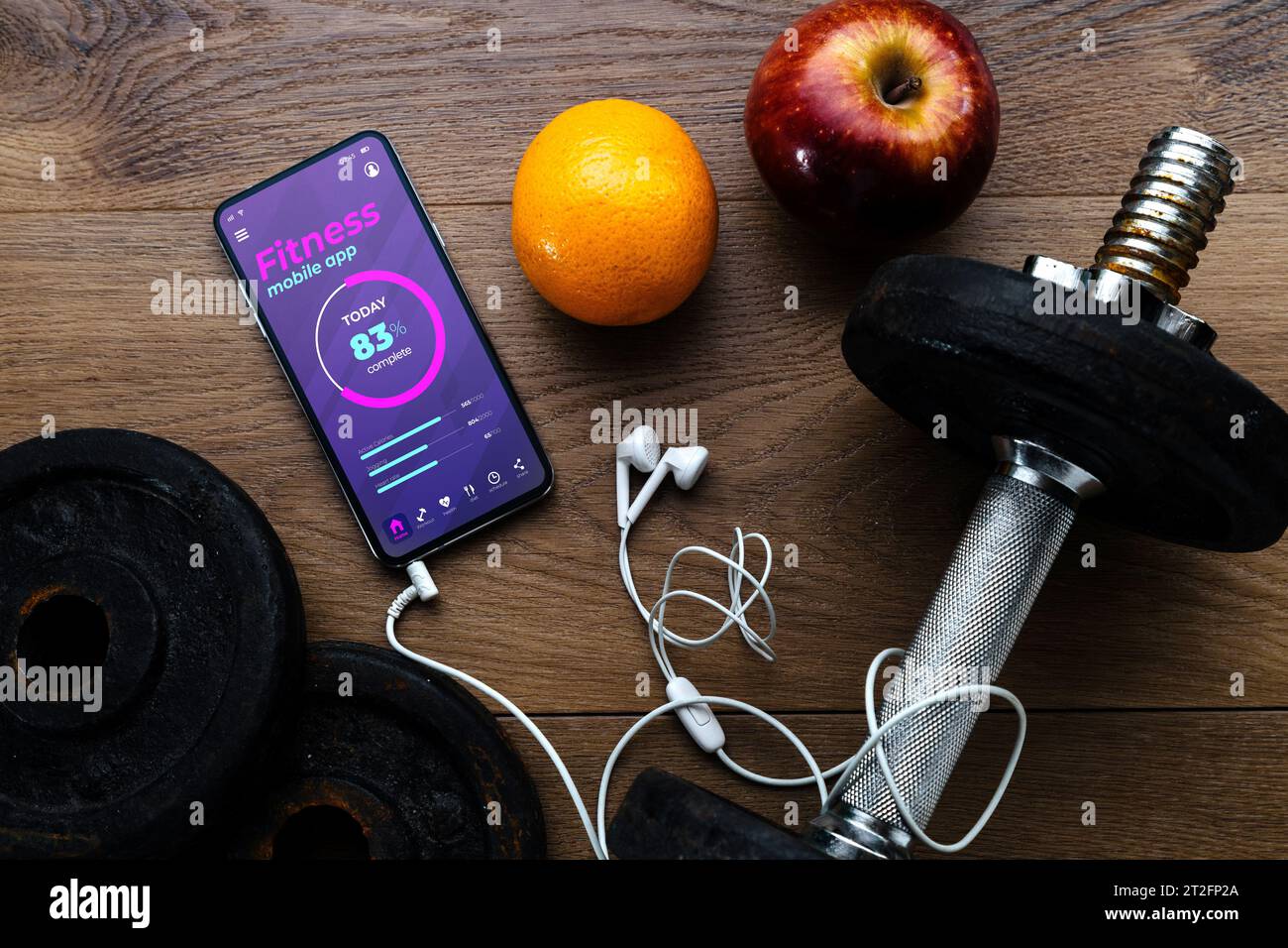Top view of workout and fitness dumbbell, fresh fruit and smartphone ...