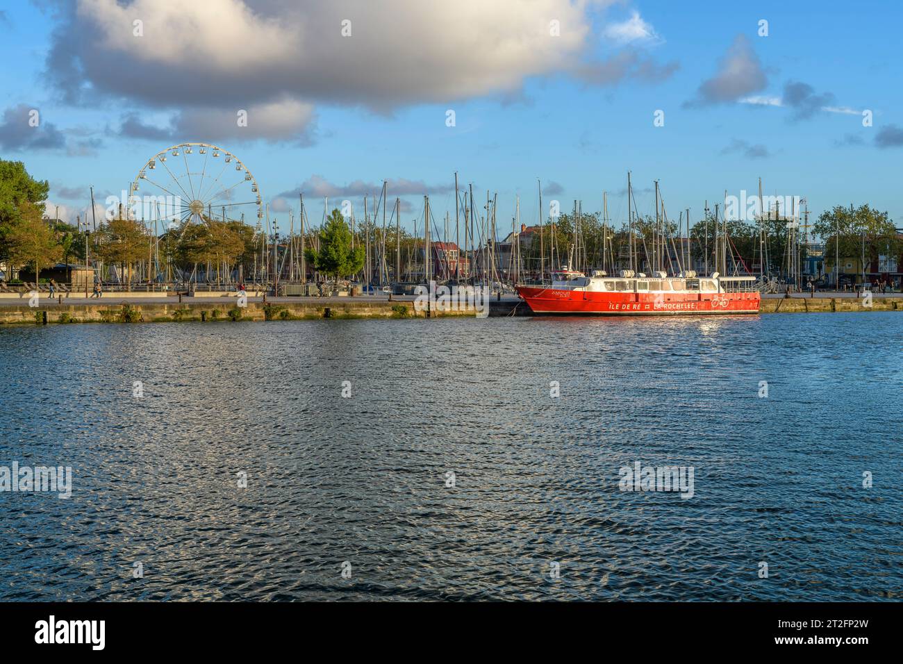 The red Ferry to l'île de Ré in evening light at the beautiful seaside ...