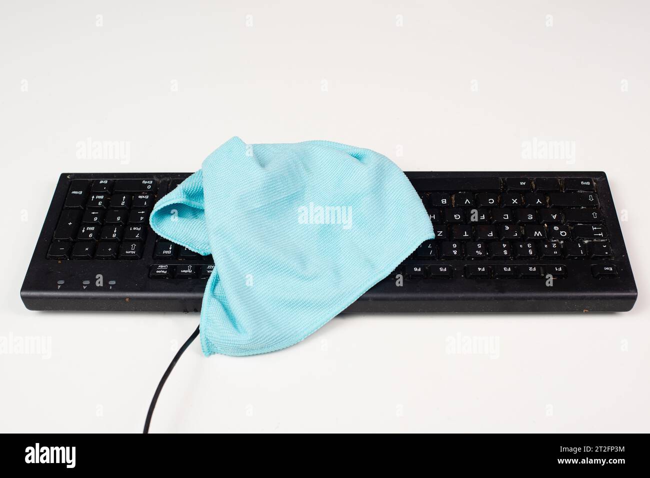 Cleaning computer keyboard in office with a rag cloth, dusty and dirty ...