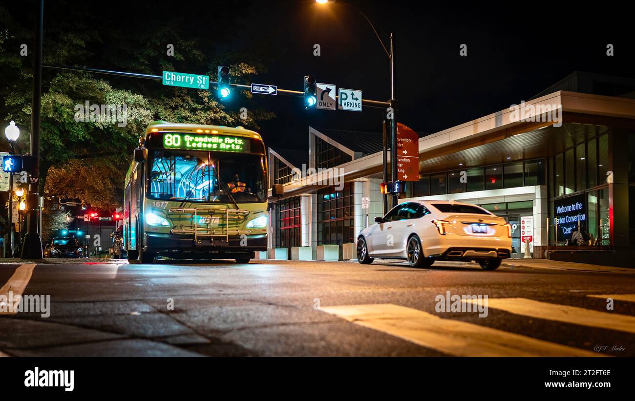 A night cityscape featuring a brightly lit bus, with the same color ...