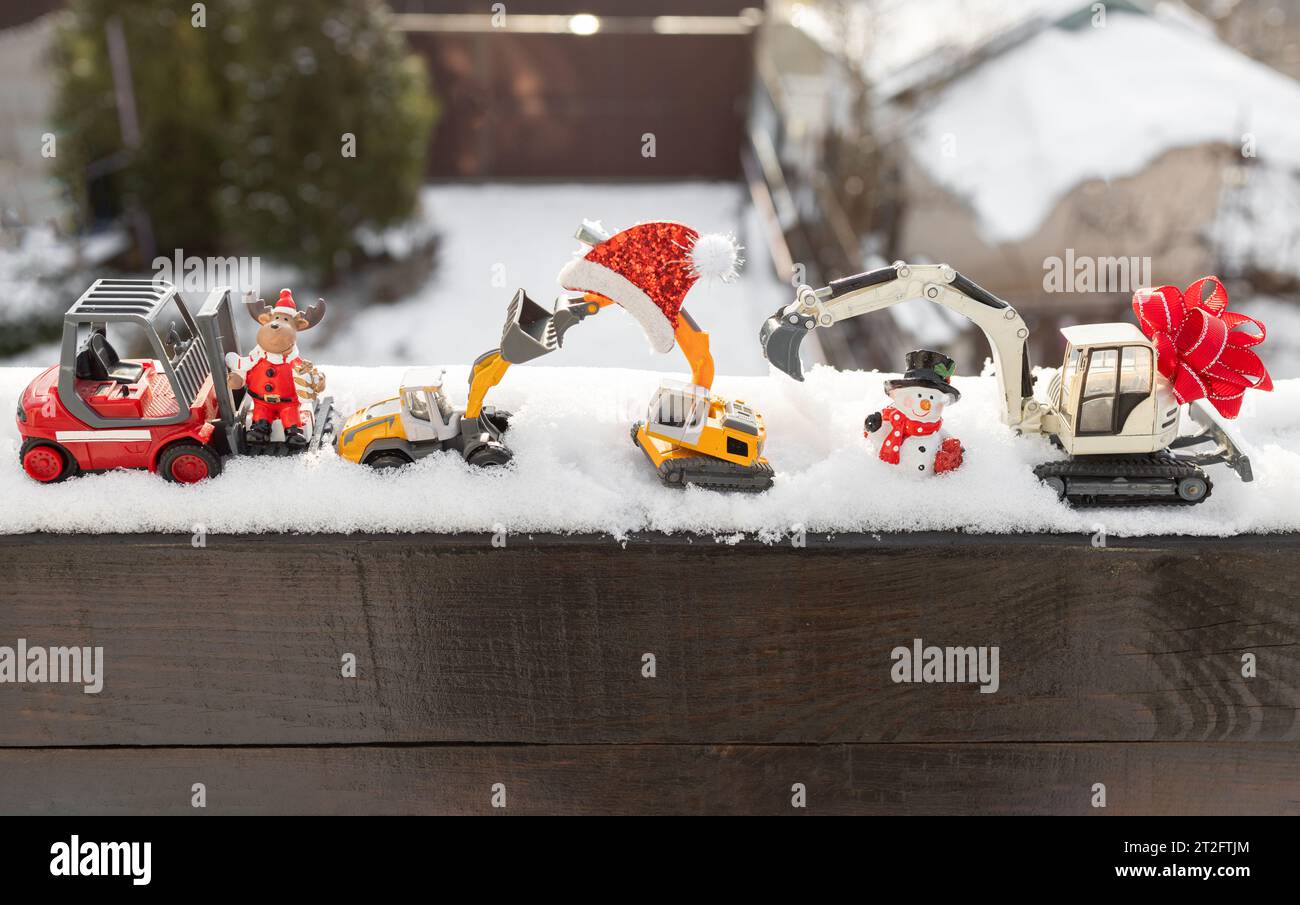 models of toy excavators and warehouse loader, souvenir snowman in the ...