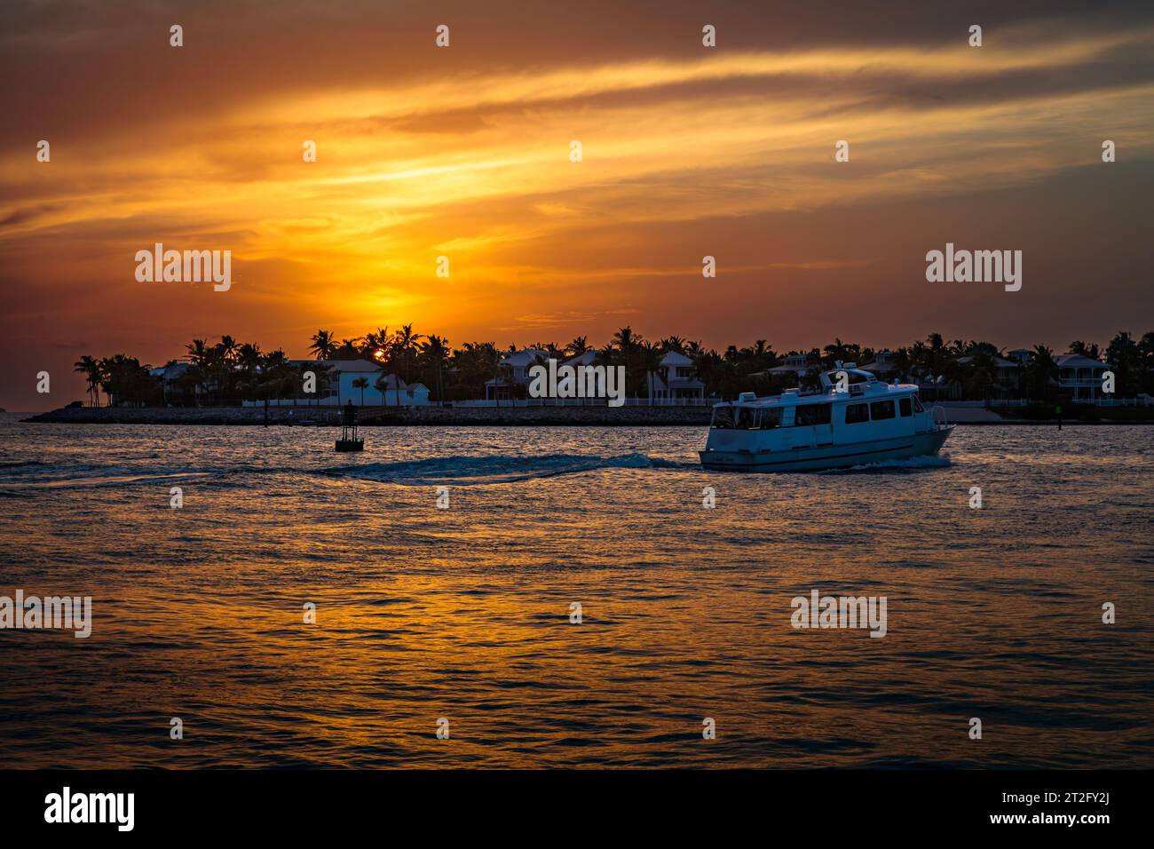Mallory Square, Key West, Florida, USA: the sun sets over Sunset Key ...