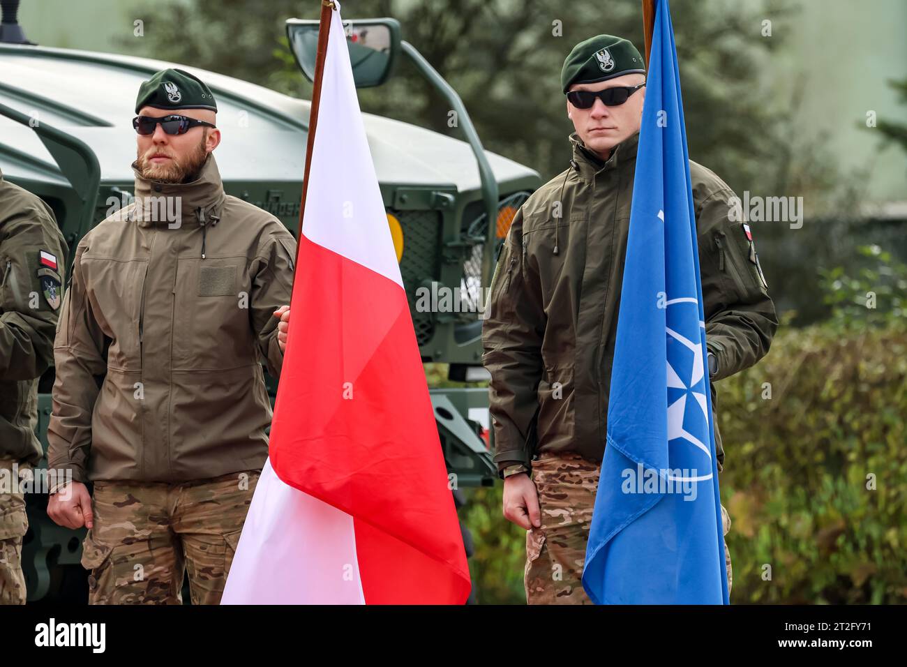 Servicemen with NATO and Polish natinal flag stand during the ceremony ...