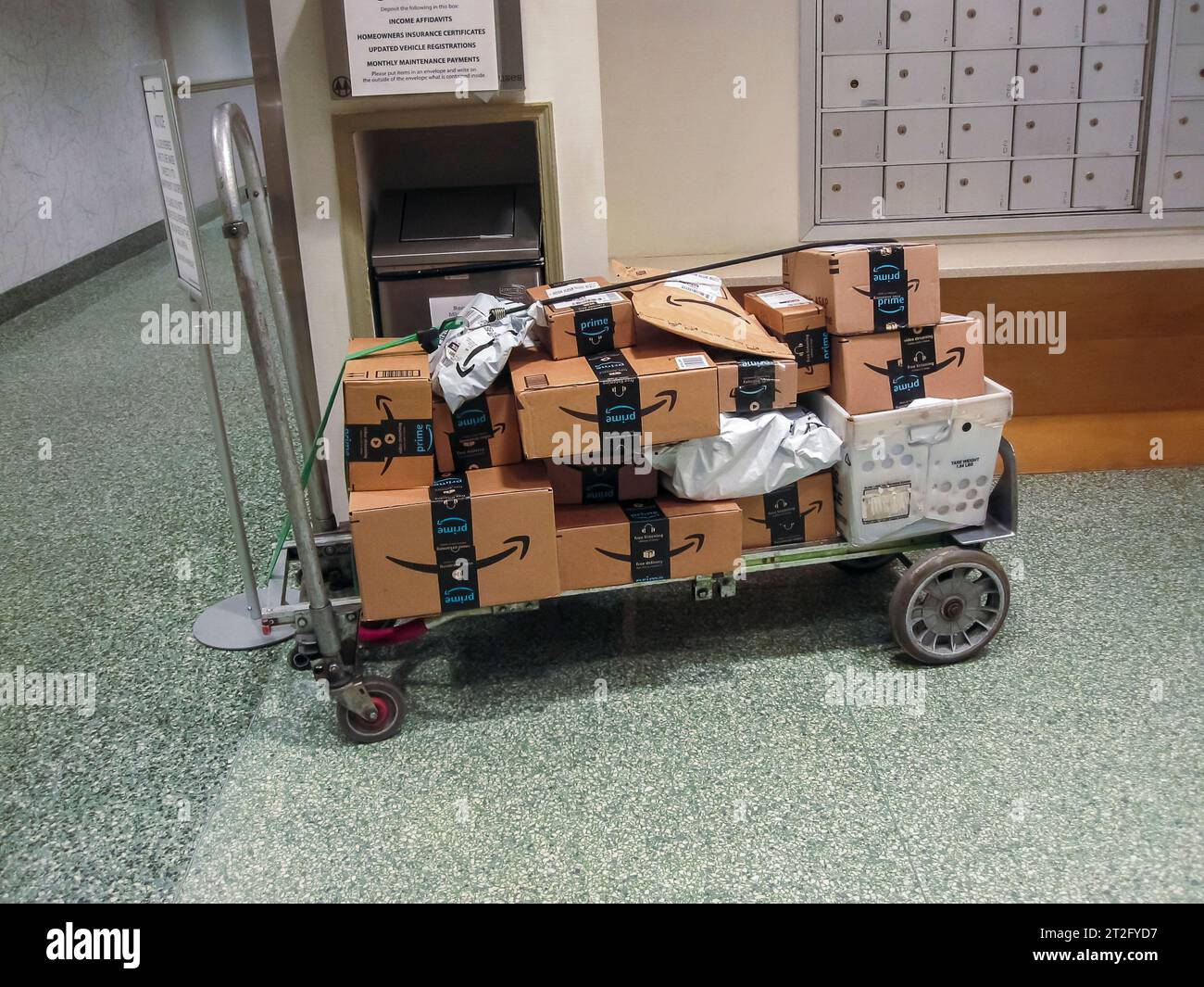 A handcart laden with packages sits unattended in an apartment building ...