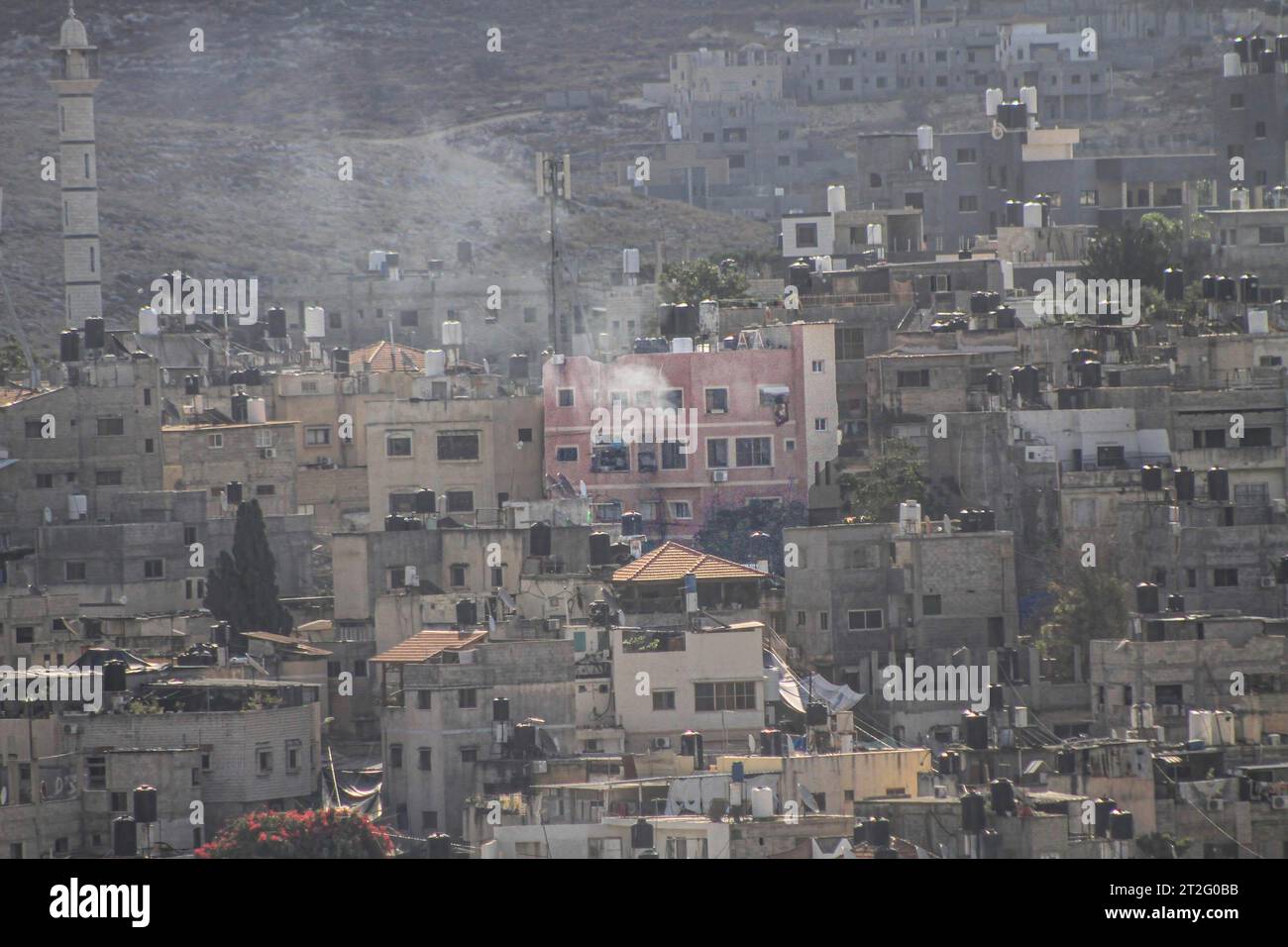 Tulkarm, Palestine. 19th Oct, 2023. Smoke rises from homes and roads ...