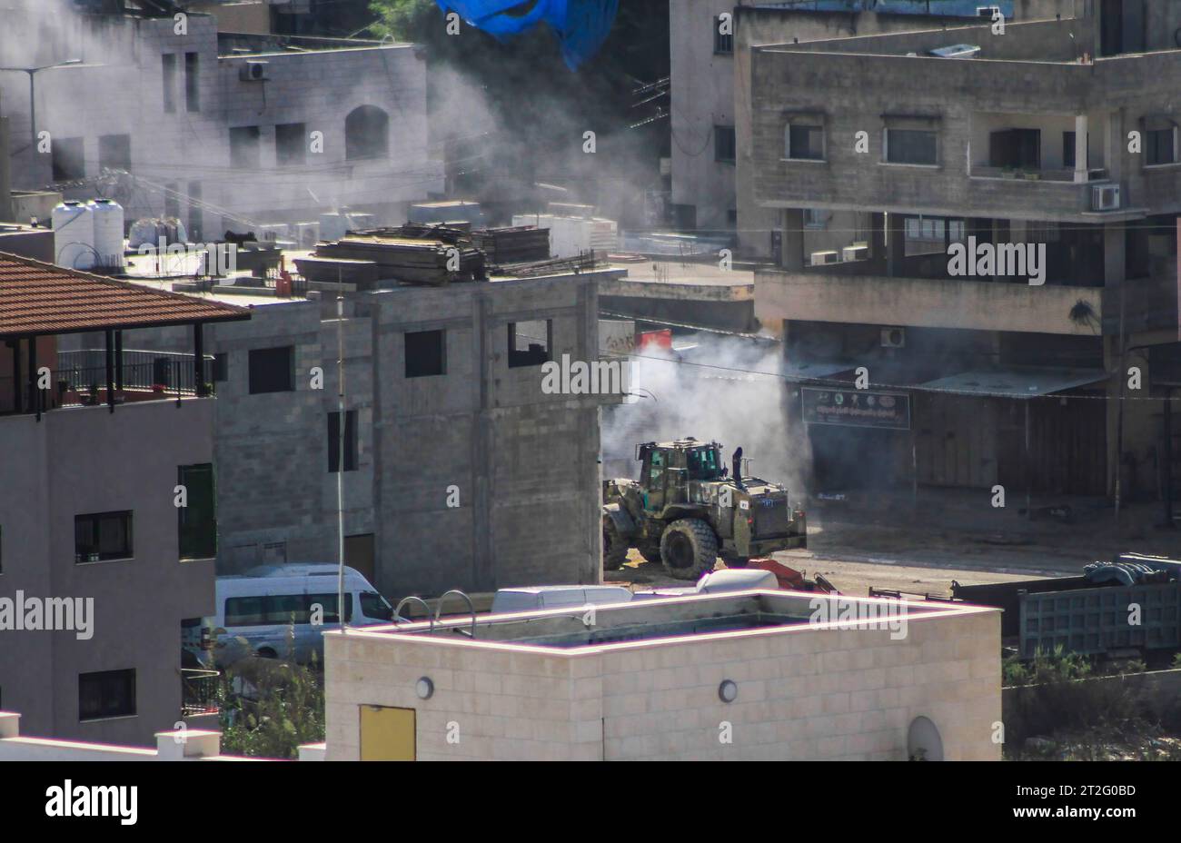 Tulkarm, Palestine. 19th Oct, 2023. Smoke rises from an armored Israeli ...