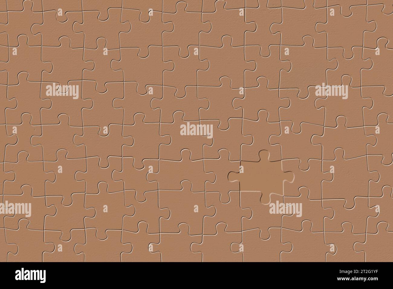 Embossed, missing piece of a light brown jigsaw puzzle Stock Photo - Alamy