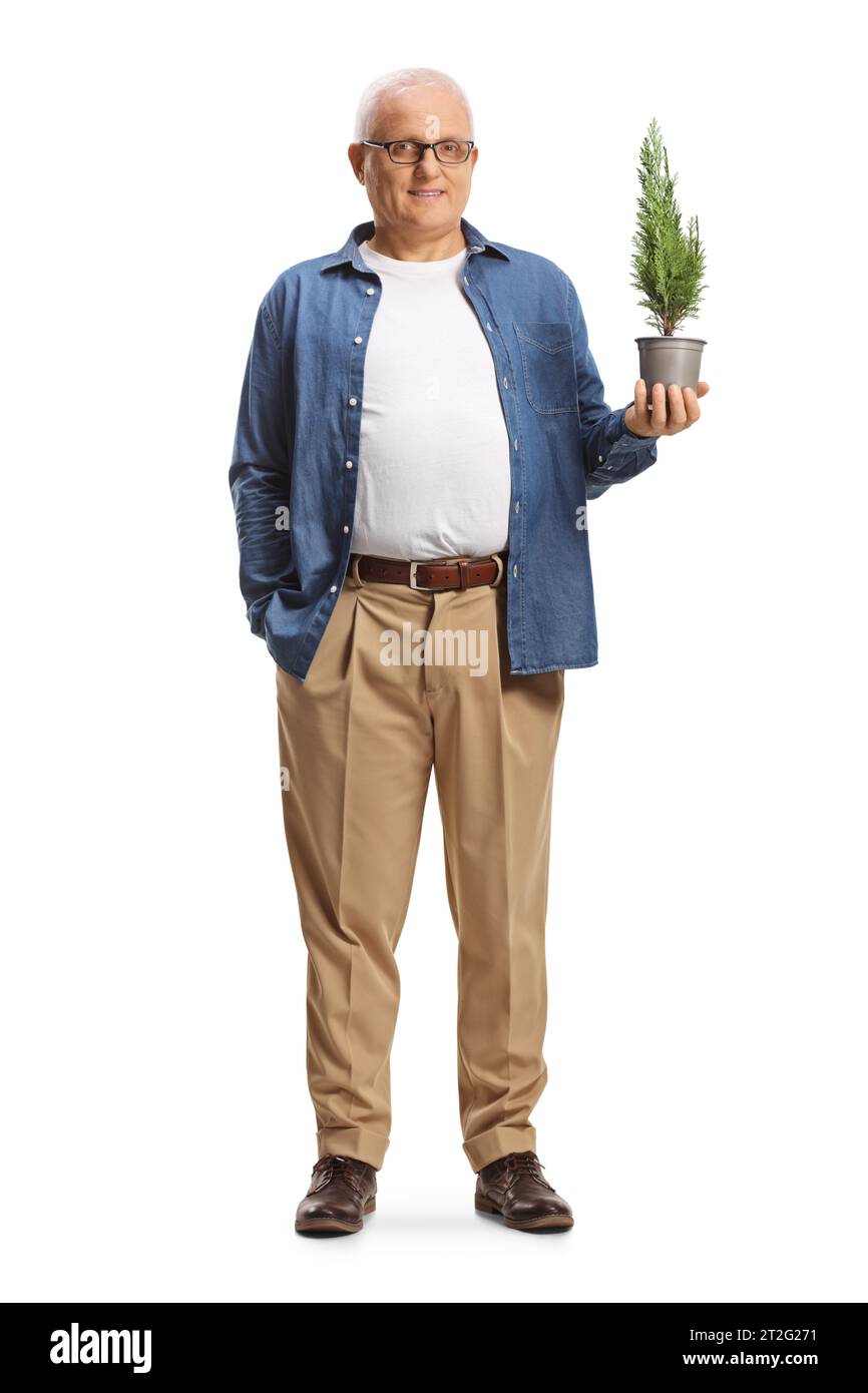Full length portrait of a mature man holding a small tree in a pot ...