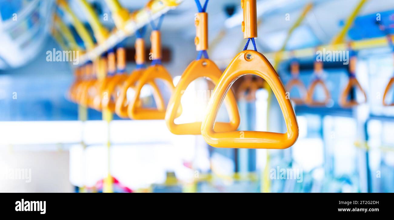 Close up of yellow handrail ring for standing passenger inside a bus ...