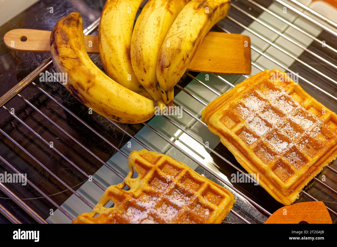Ready-made waffles that lie on a grating to cool and bananas as an ...