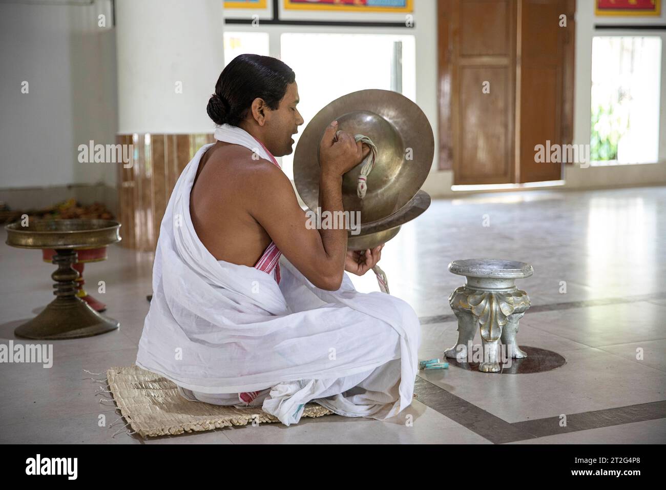Hindu monk sitting on the floor at the Uttar Kamalabari Hindu monastery ...