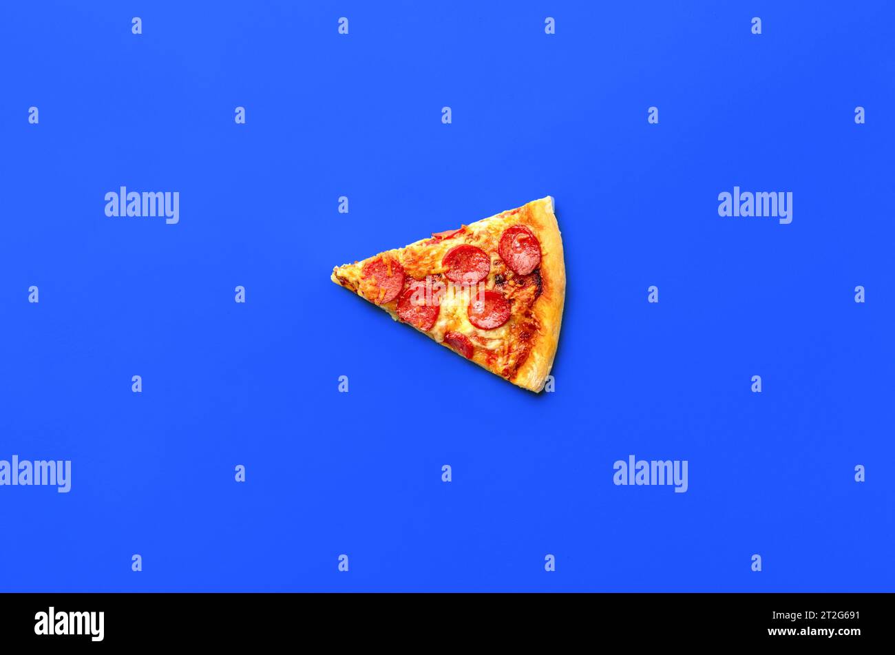 Top view with a single slice of pepperoni pizza minimalist on a blue ...