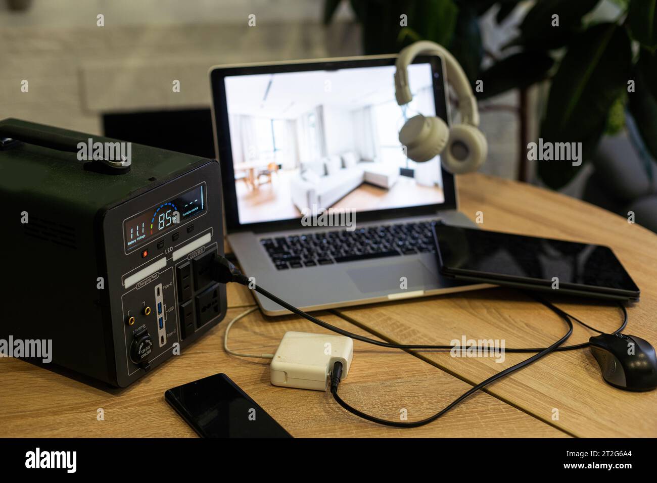 Portable power station charging devices on table in living room Stock ...