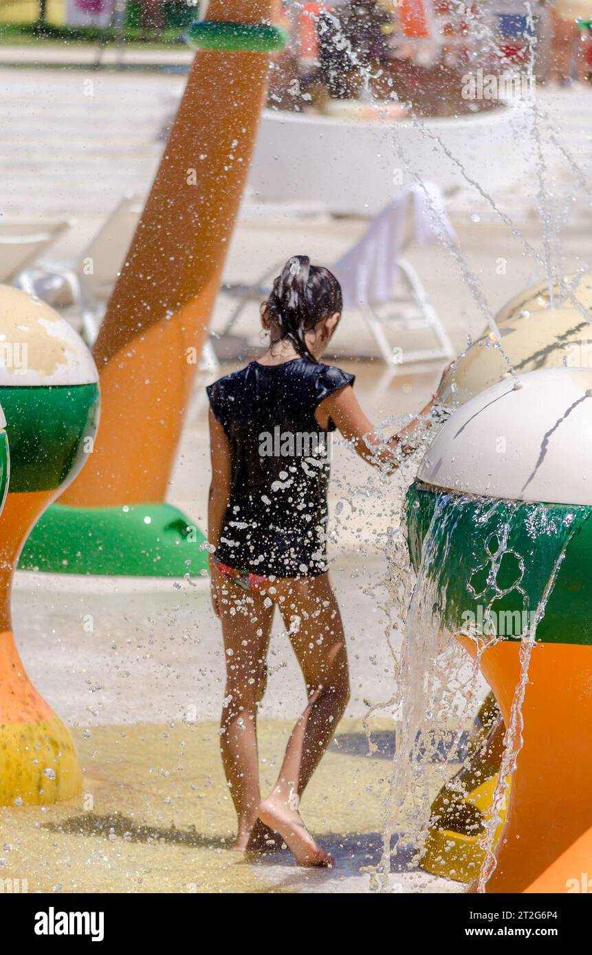 Little Girl Having Fun at the Splash Pad in a Water Park. Colorful ...