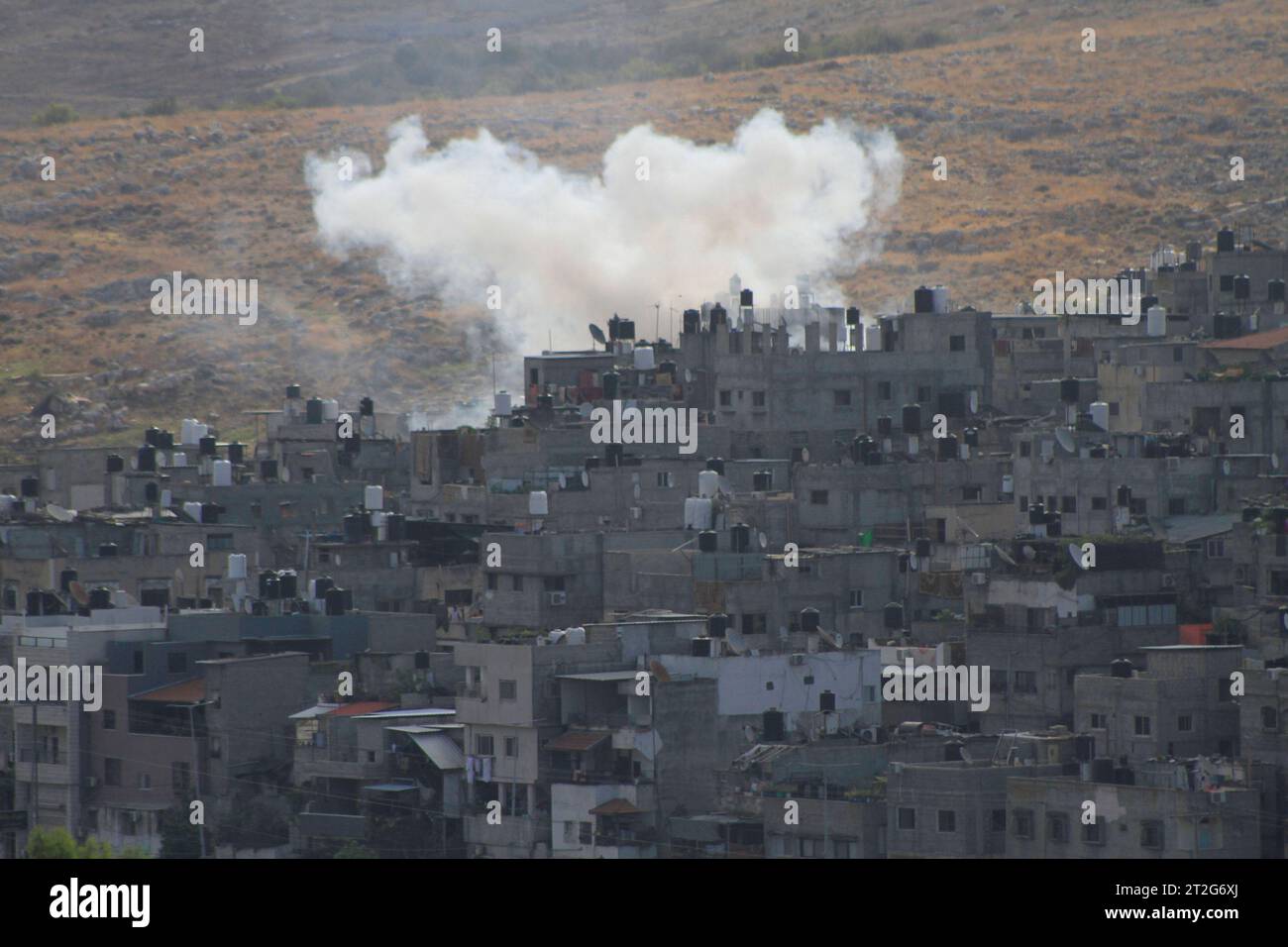 Smoke rises from homes and roads during the Israeli storming of the ...