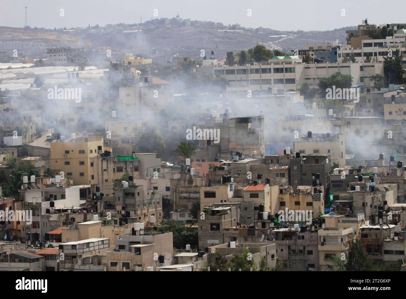 Smoke rises from homes and roads during the Israeli storming of the ...