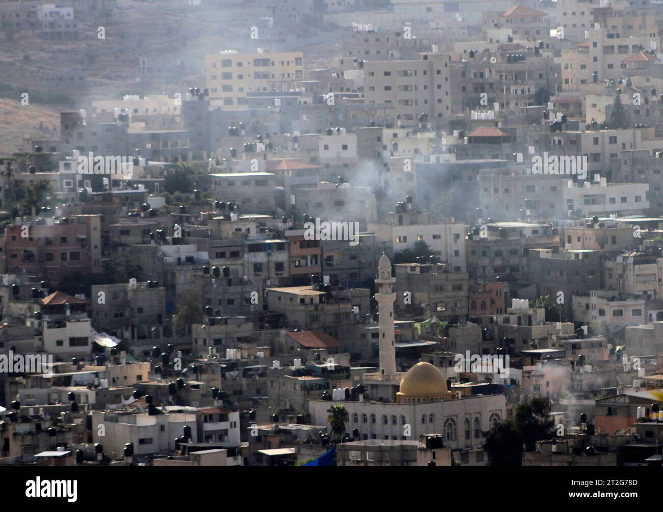 Smoke rises from homes and roads during the Israeli storming of the ...