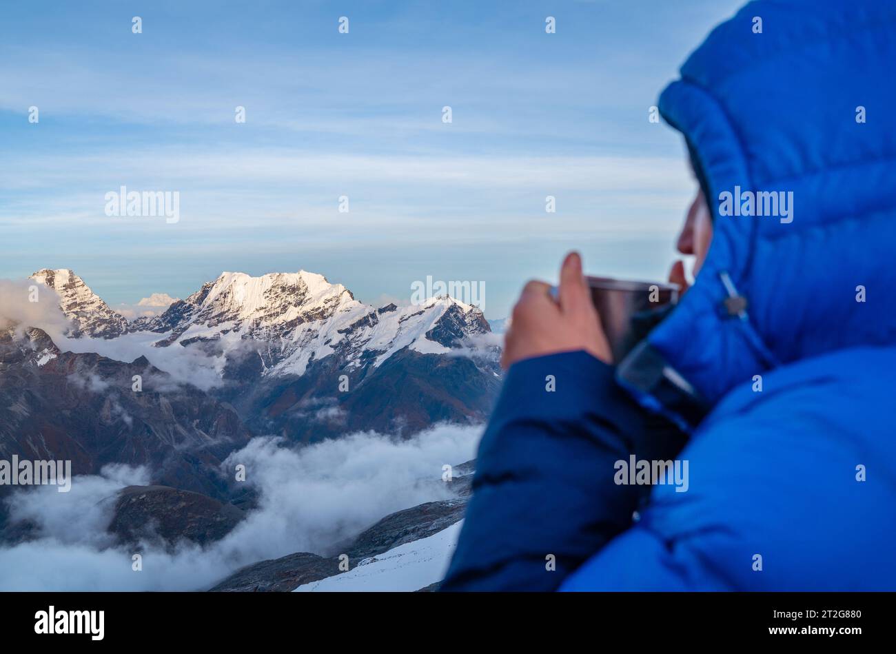 High altitude female mountaineer dressed red warm dawn jacket holding ...