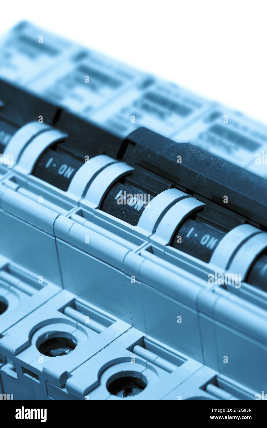 Mains electricity circuit breakers isolated on a white background. With ...
