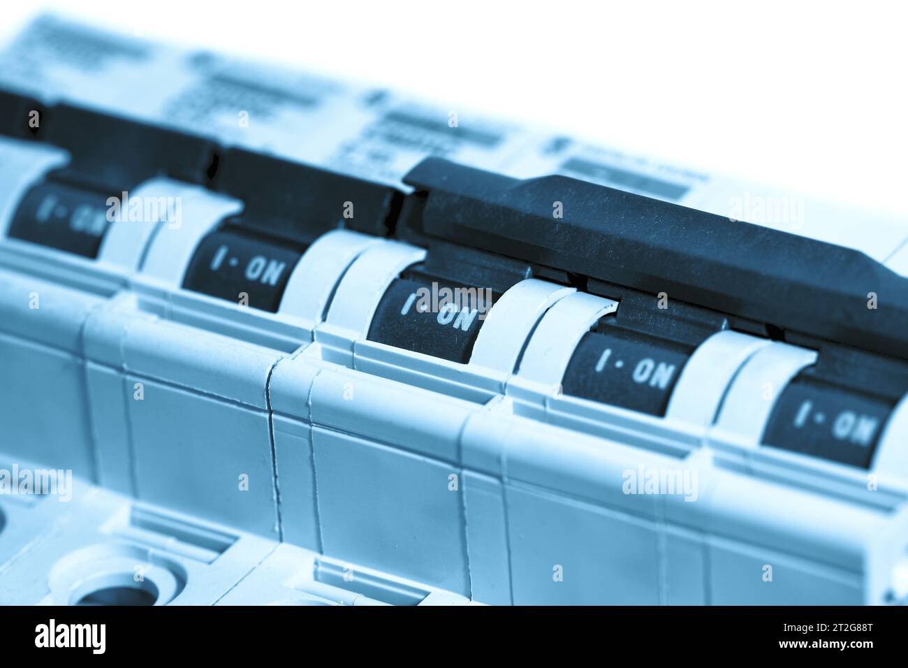 Mains electricity circuit breakers isolated on a white background. With ...