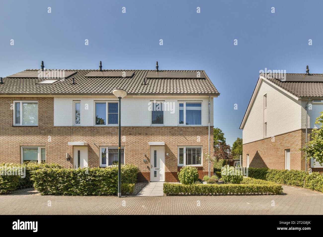 two houses in the same area, one is white and the other is red with ...