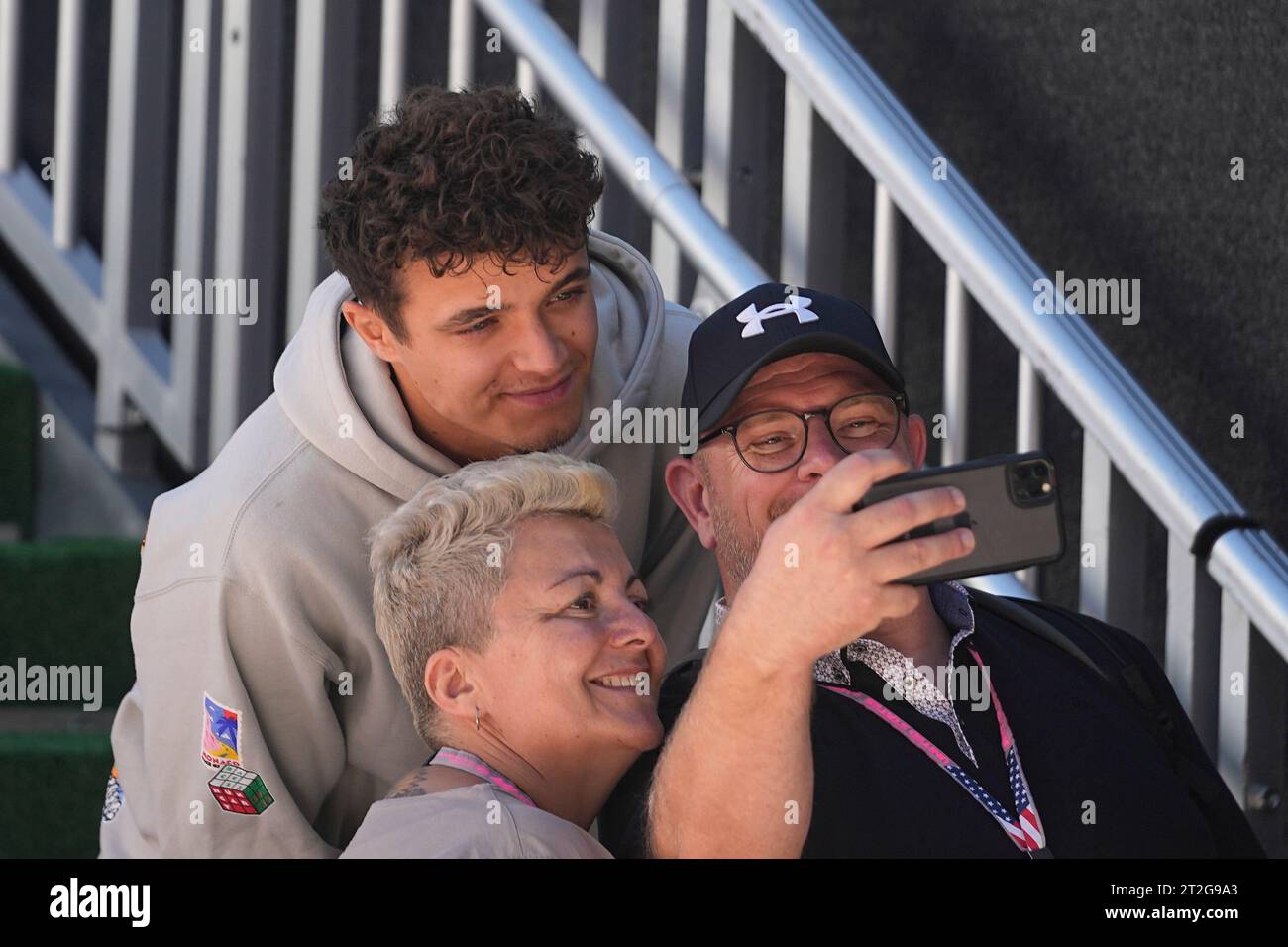 McLaren driver Lando Norris of Britain poses for a photo with fans ...