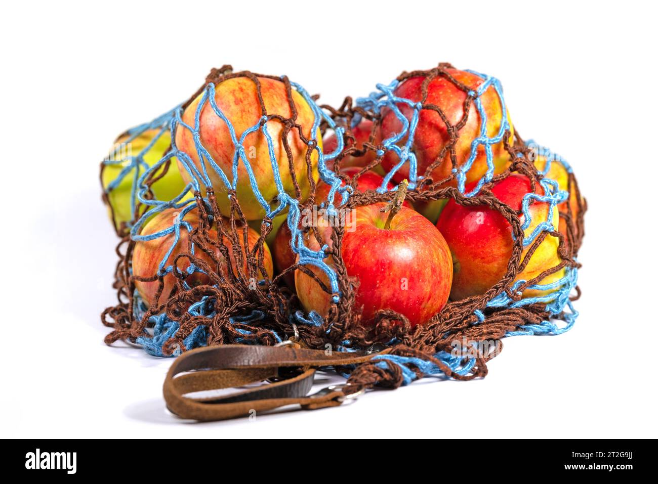 Apples in the net against a white background Stock Photo - Alamy