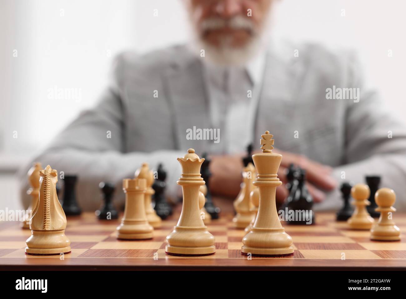 Chess pieces on chessboard, selective focus. Man participating in ...