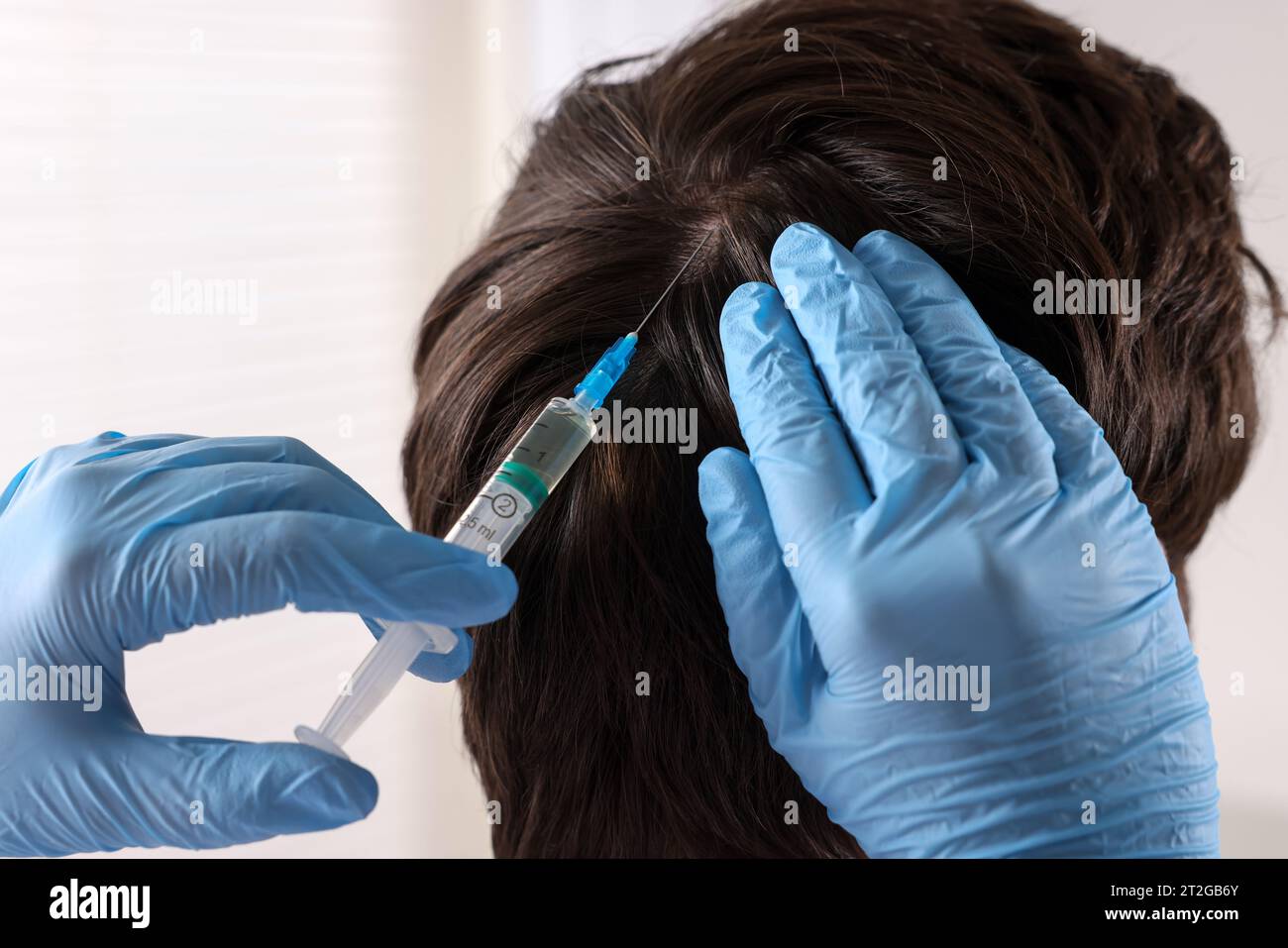 Trichologist giving injection to patient in clinic, closeup Stock Photo ...