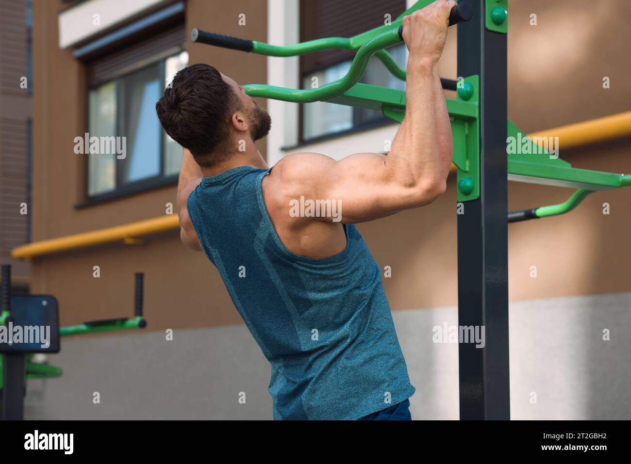 Man doing pull ups at outdoor gym Stock Photo - Alamy