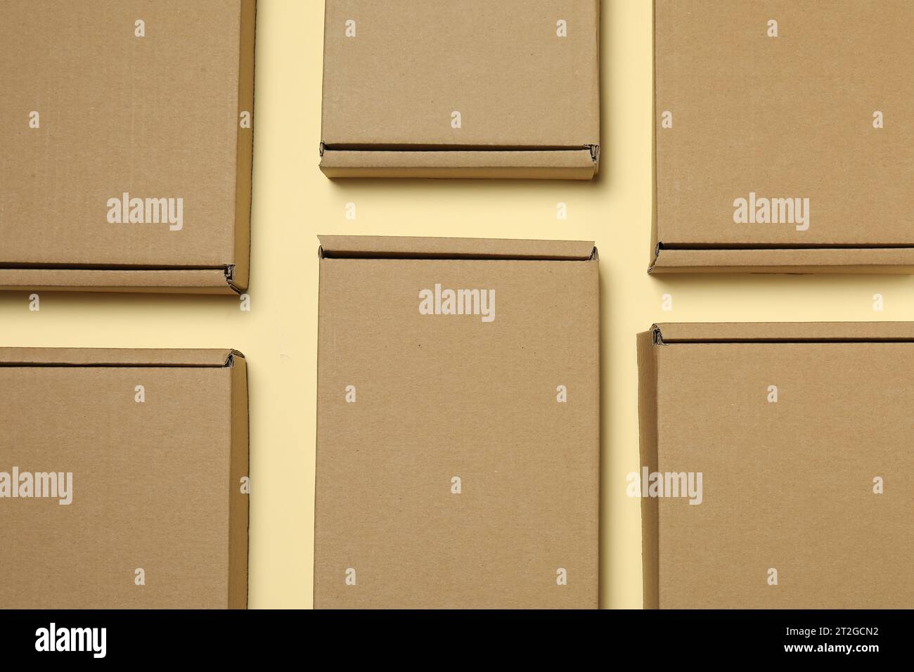 Many closed cardboard boxes on pale yellow background, flat lay Stock ...
