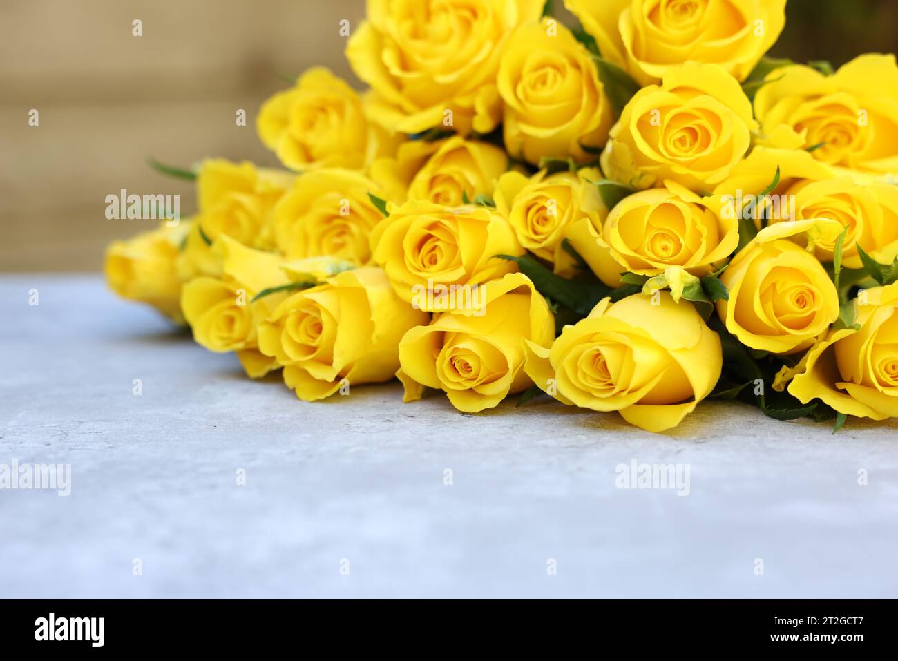 Beautiful bouquet of yellow roses on light table Stock Photo - Alamy
