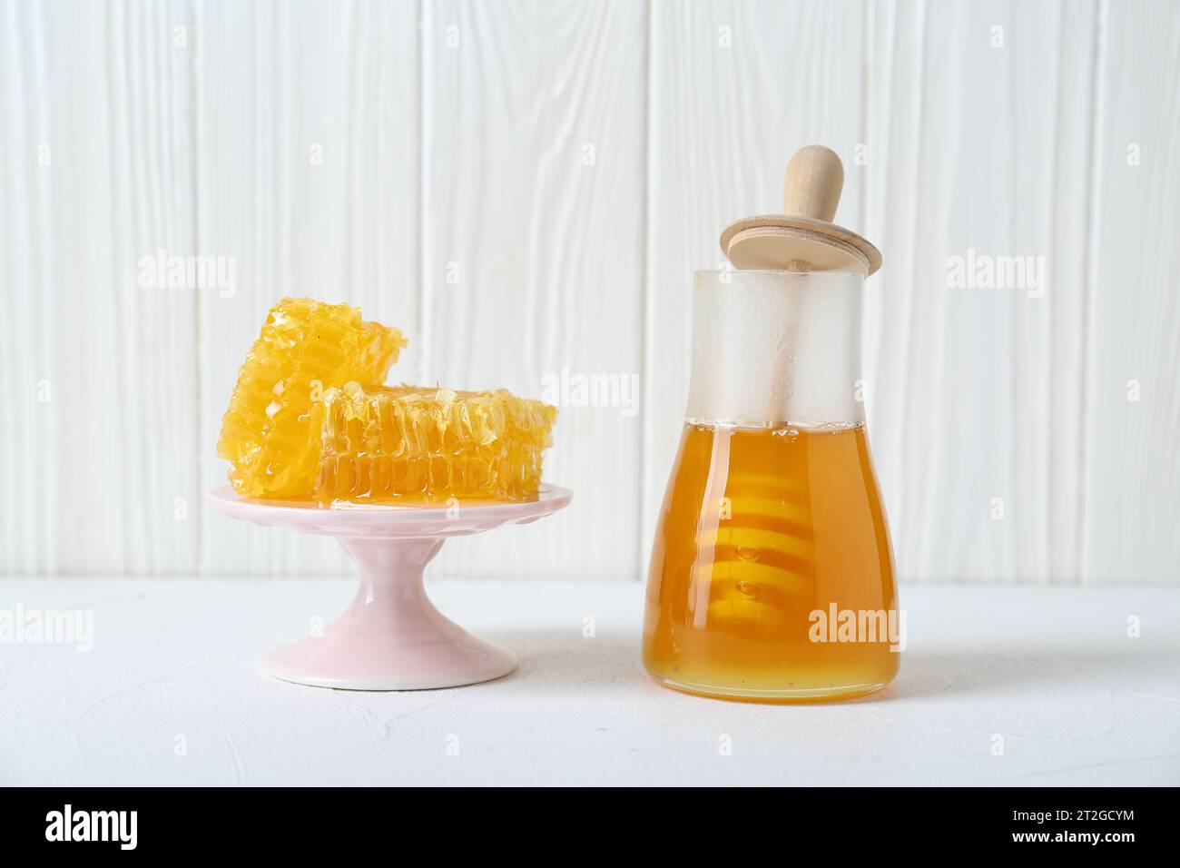 Stand with natural honeycombs and honey on white table Stock Photo - Alamy