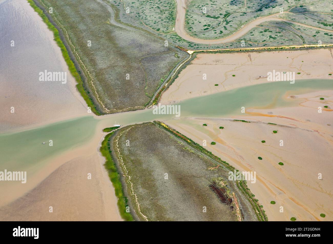 Aerial view of sailboat in a narrow channel of the muddy Sacramento ...