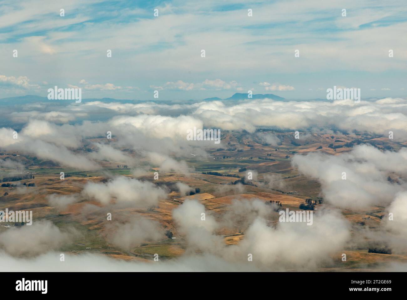 Clouds drift over the rolling hills of wine country with aerial view of ...