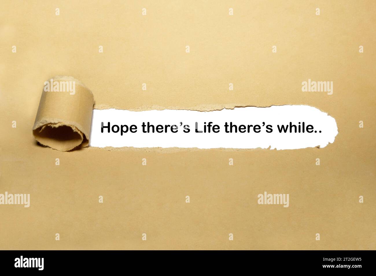 Text quote of "hope there's life there's while" appearing behind torn ...