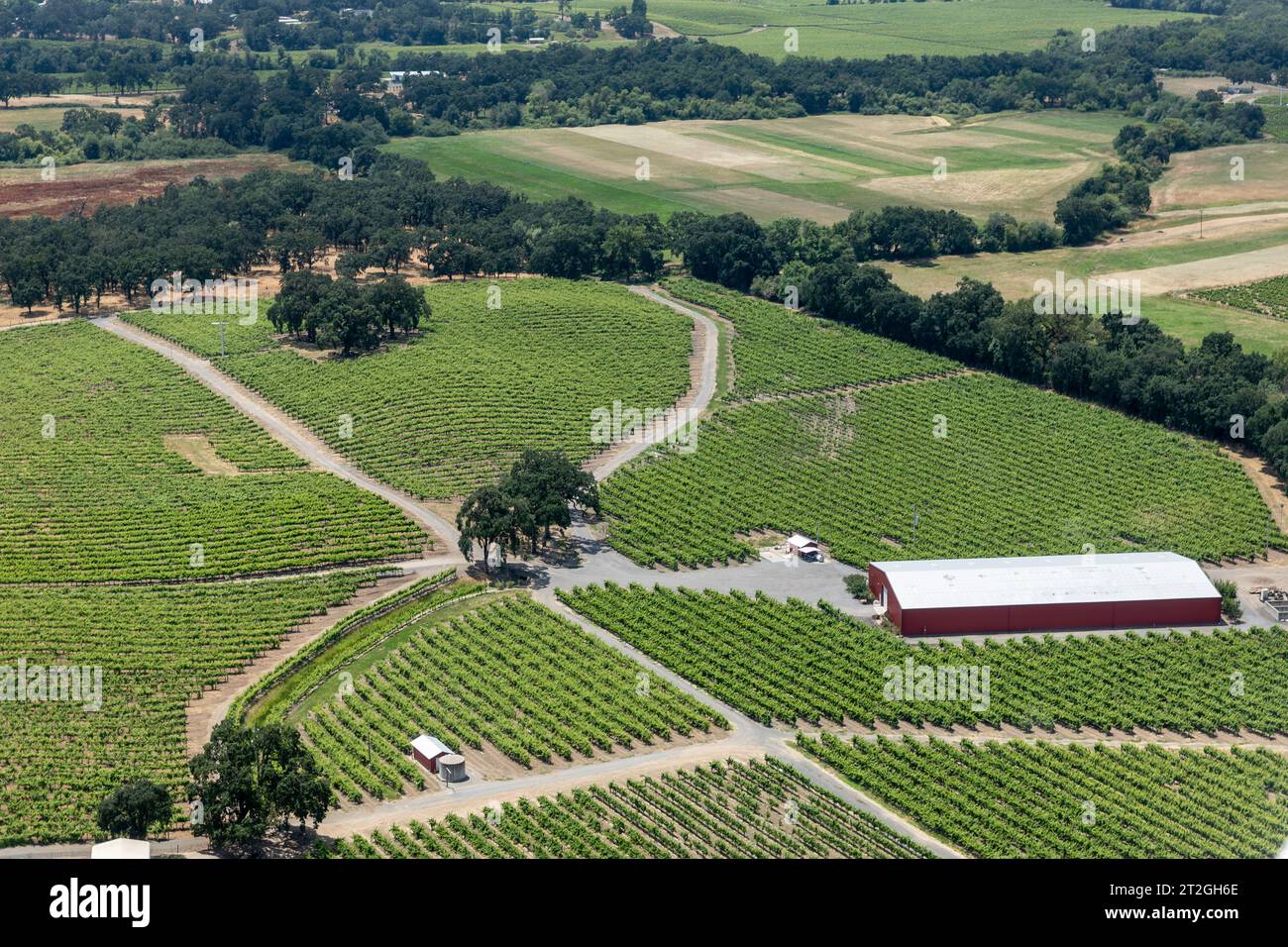 Aerial view of roadways crossing the fertile green crops of norther ...