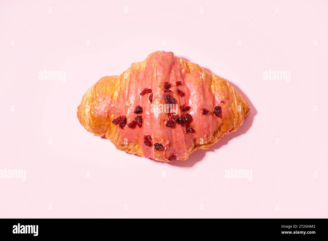 Sweet croissant on pink background Stock Photo - Alamy